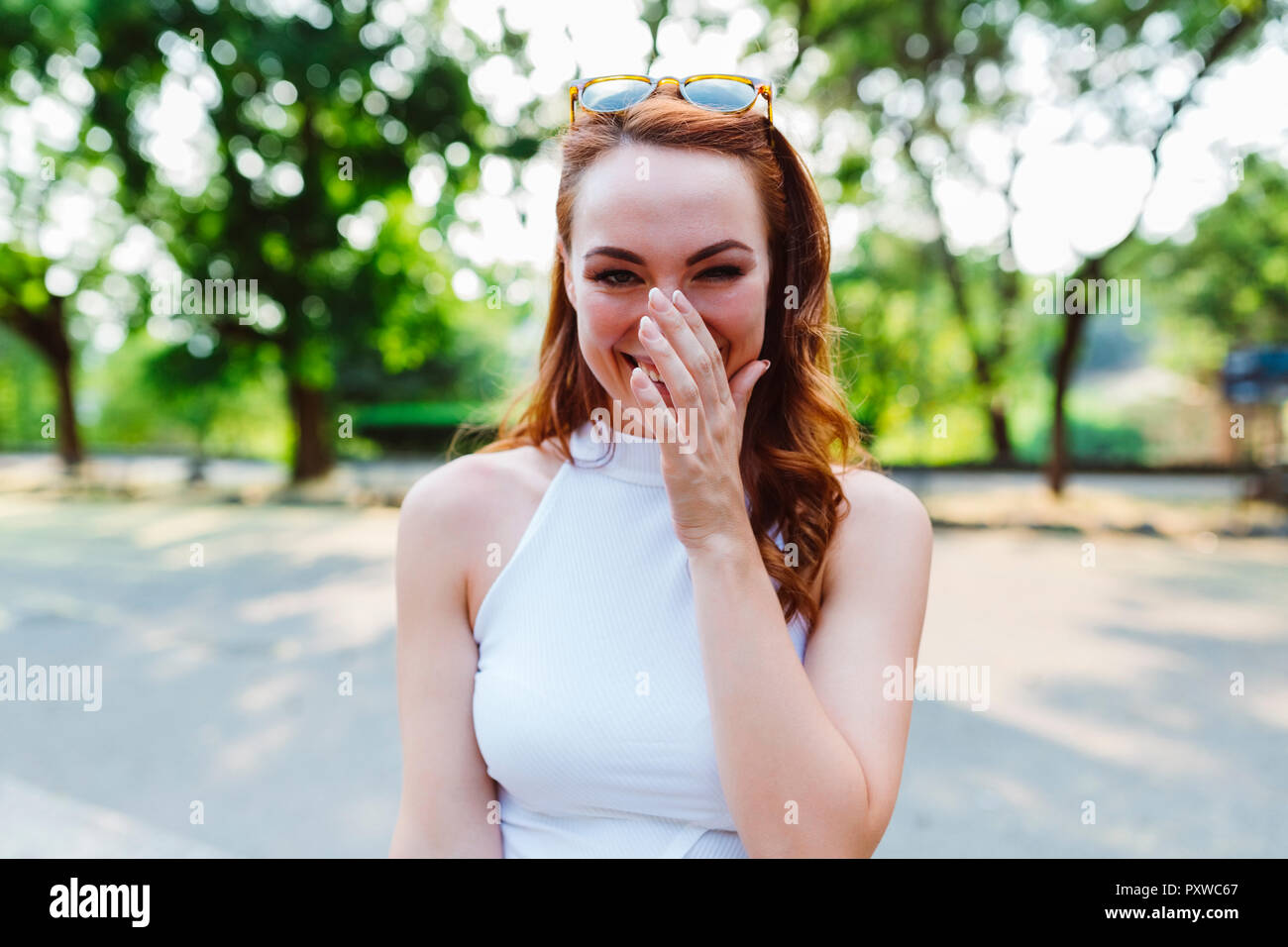 Woman laughing hand over mouth hi-res stock photography and images - Alamy