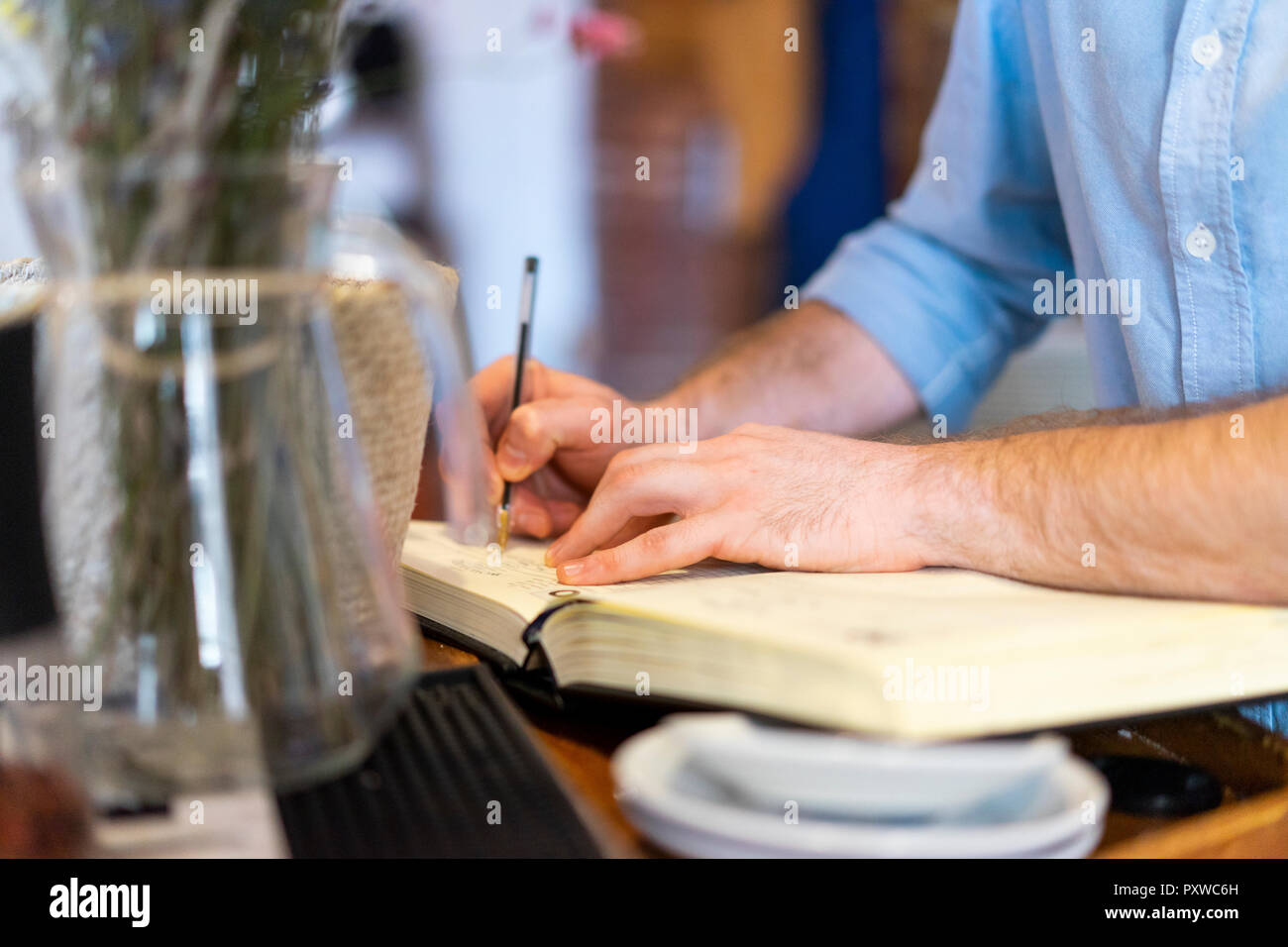 Man writing in notebook hi-res stock photography and images - Alamy
