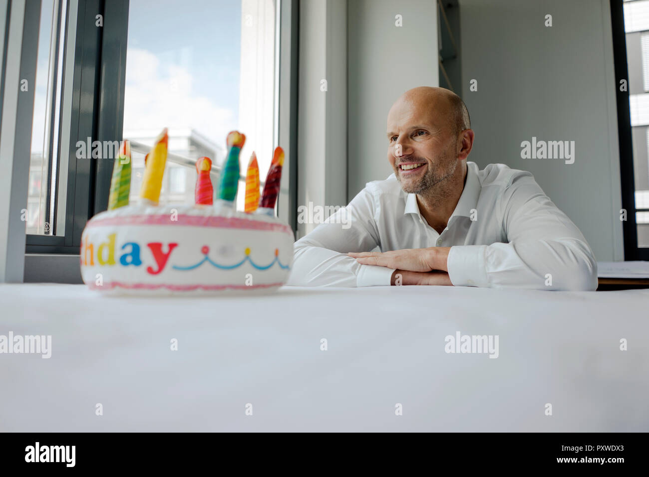Businessman celebrating his birthday in the office, making a wifh Stock ...