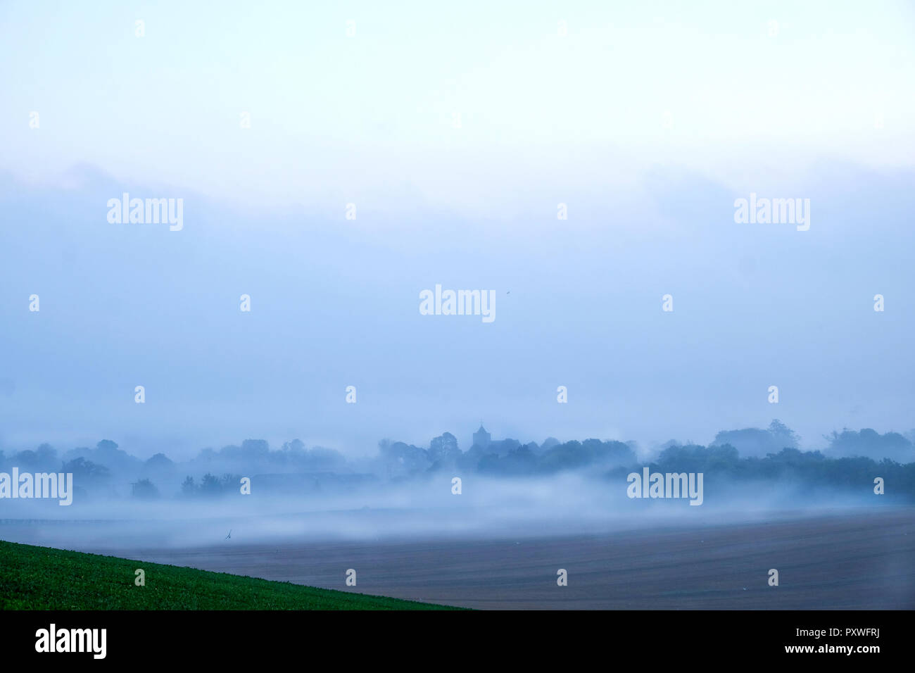 British countryside looking across a sweeping field to an old english ...