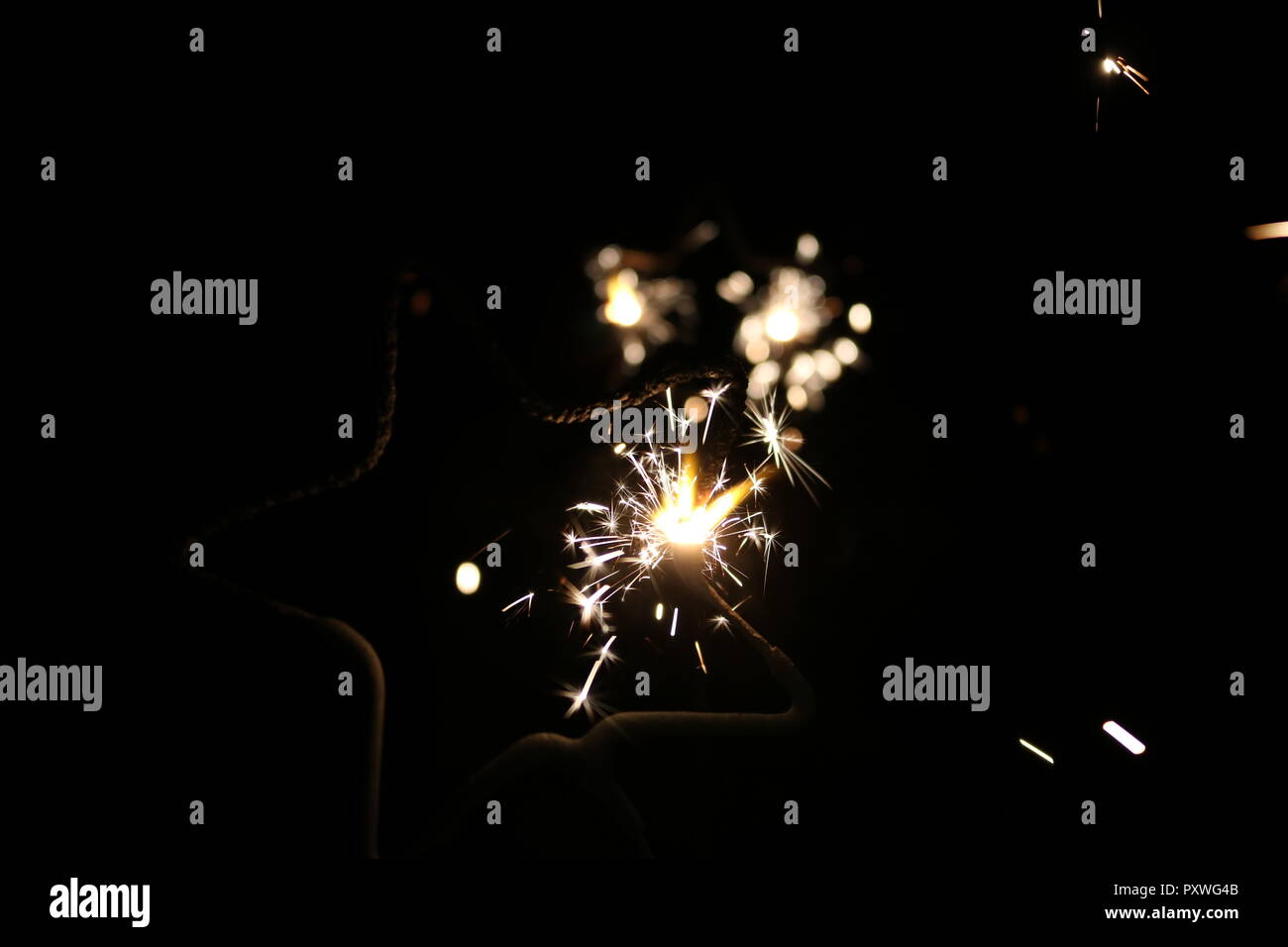 Sparklers in the night with sparks flying in the dark for bonfire night ...