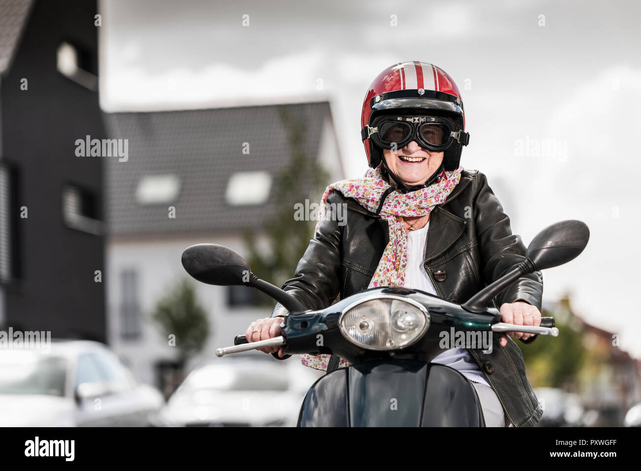 Lady riding scooter hi-res stock photography and images - Alamy