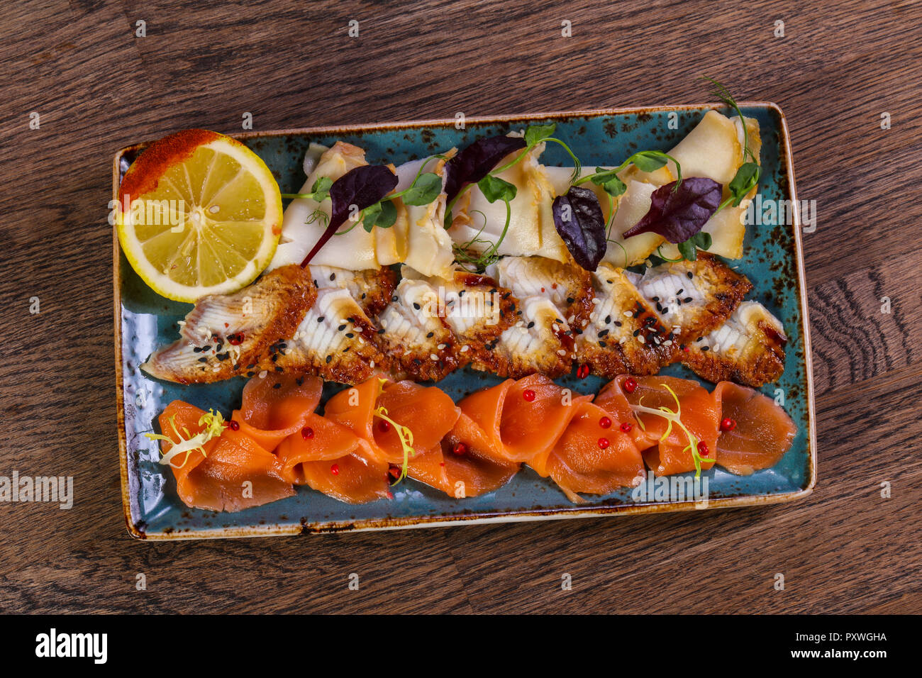 Sliced fish plate served lemon Stock Photo - Alamy