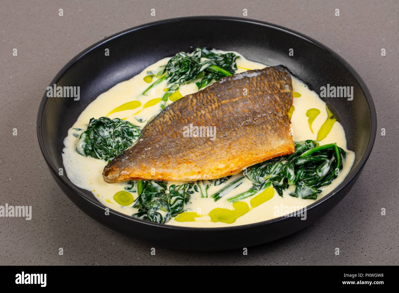 Dorada fish fillet with spinach Stock Photo - Alamy