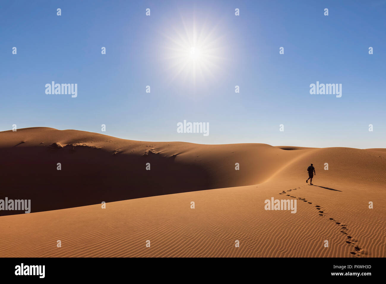 Man walking on desert road hi-res stock photography and images - Alamy