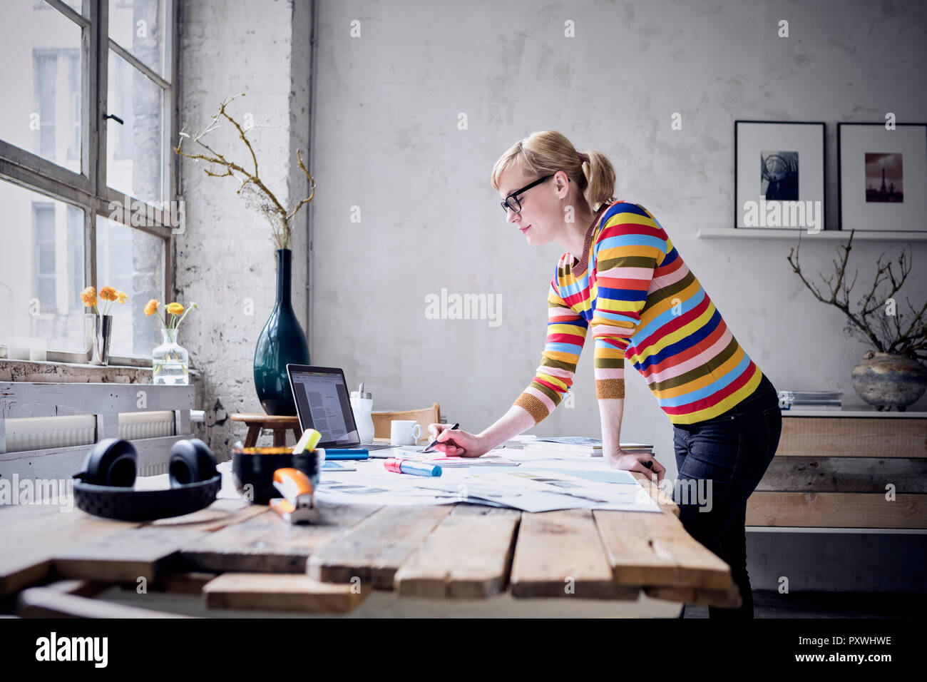 Woman bending over table hi-res stock photography and images - Alamy