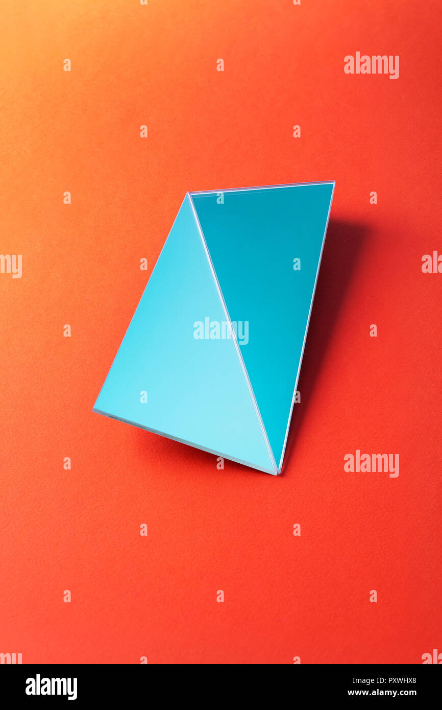 Broken rectangle shaped mirror over red background Stock Photo - Alamy