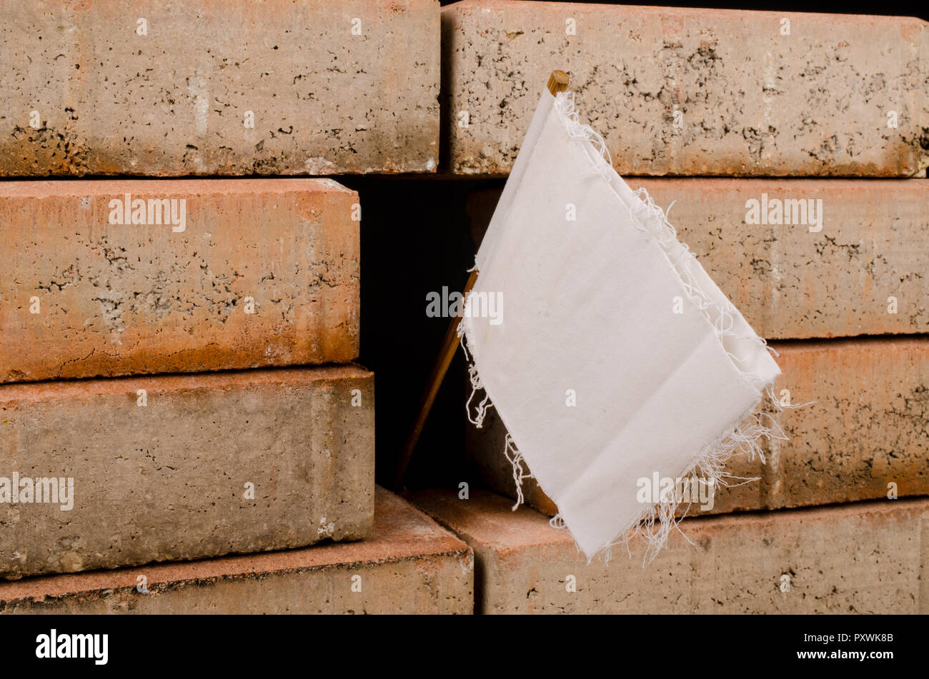 White flag on a wall, a multiple concept both on overworking and on ...