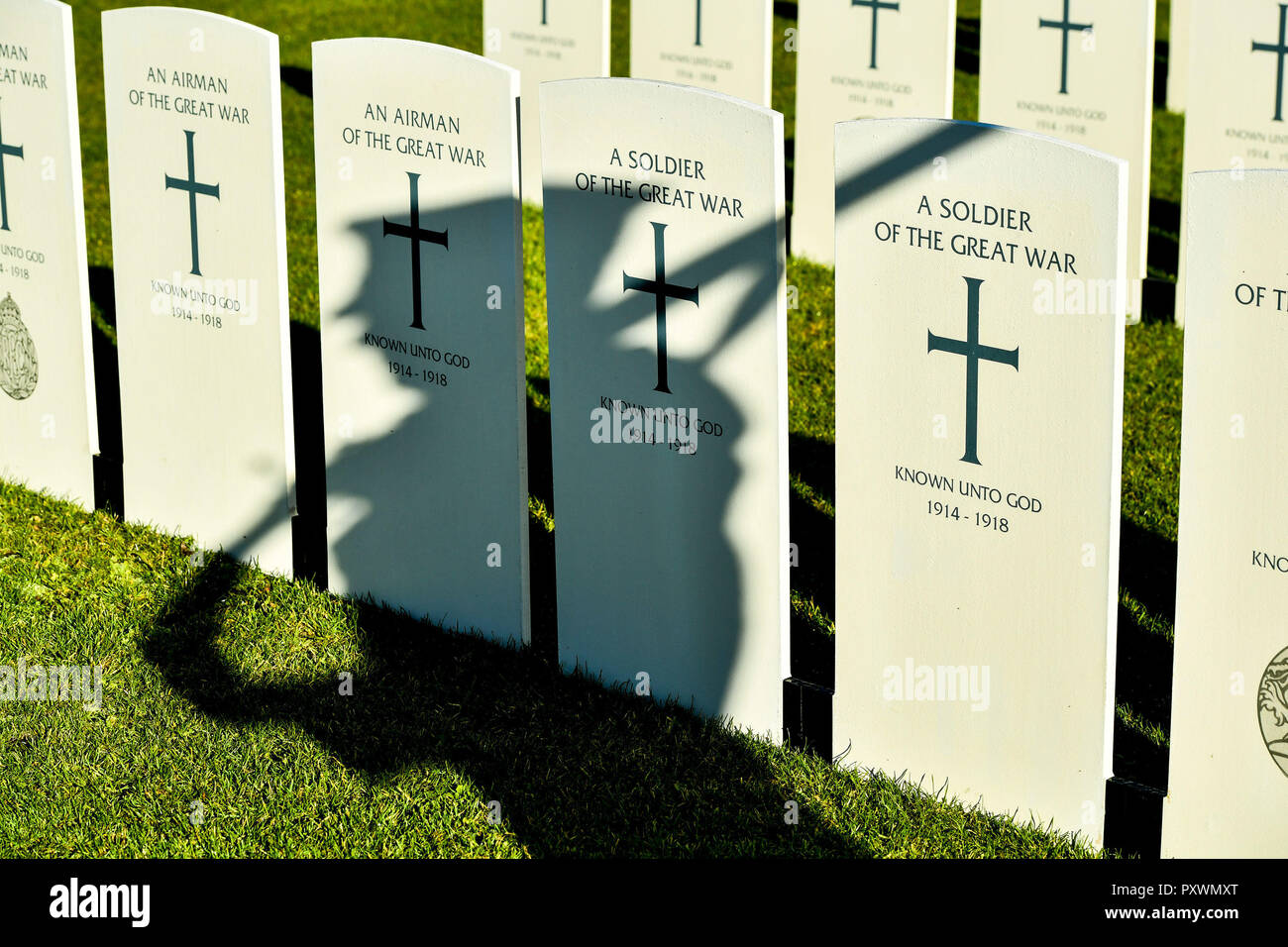 The shadow of a man dressed as a WWI soldier, is cast on replica ...