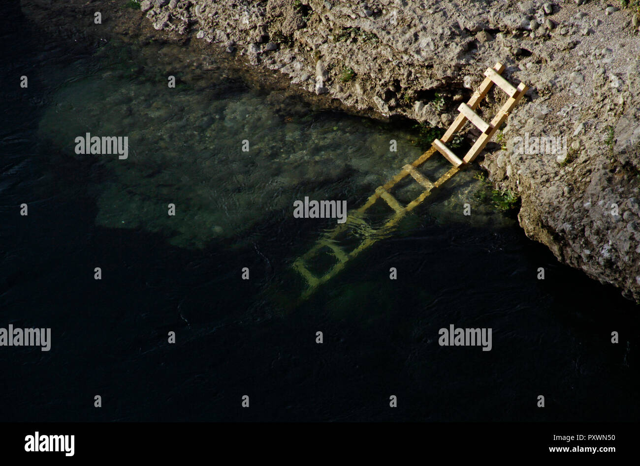 Wooden ladder leading out of a clear river Stock Photo - Alamy