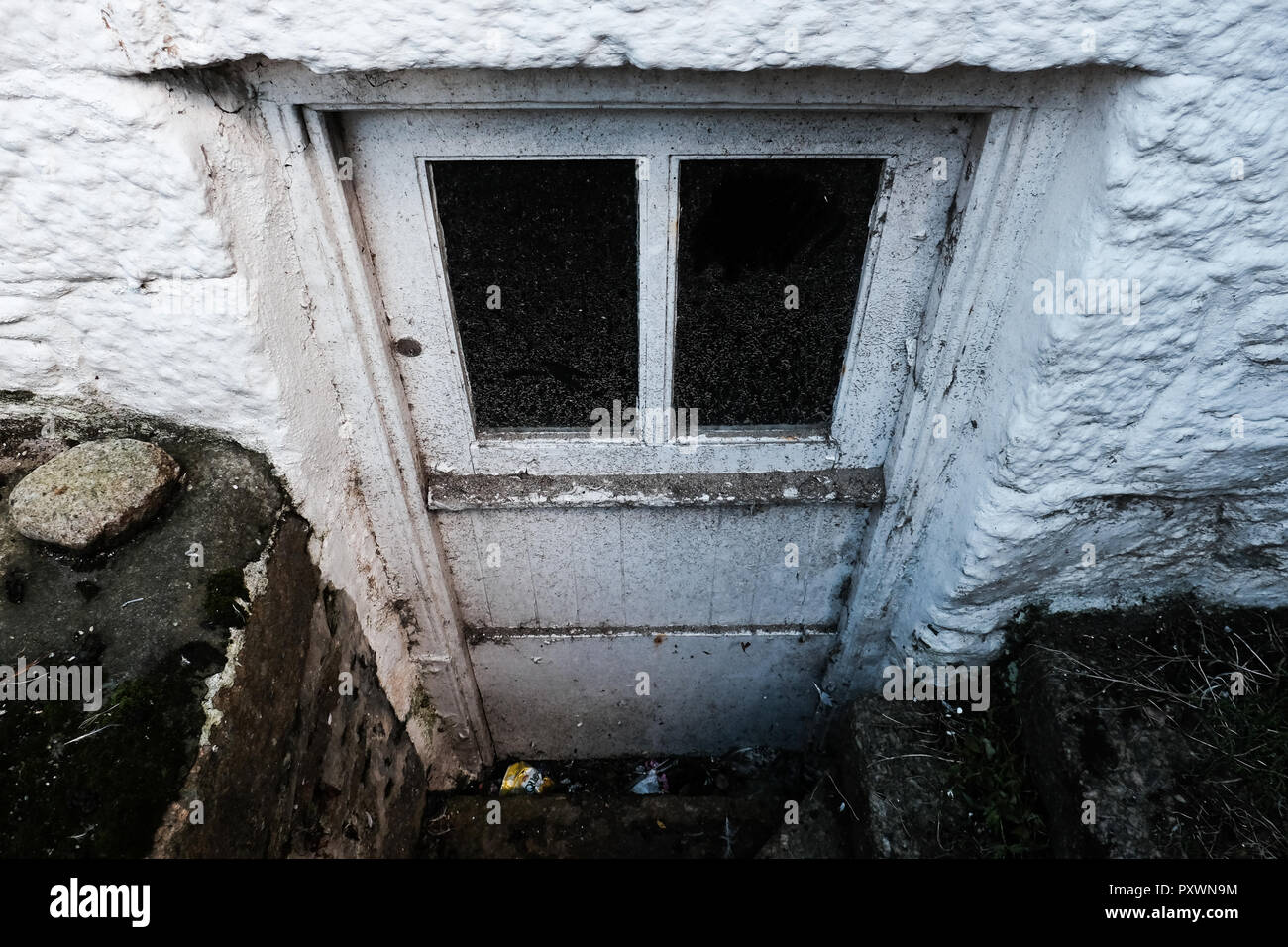 Period style wooden doorway with steep steps off a narrow alleyway in ...