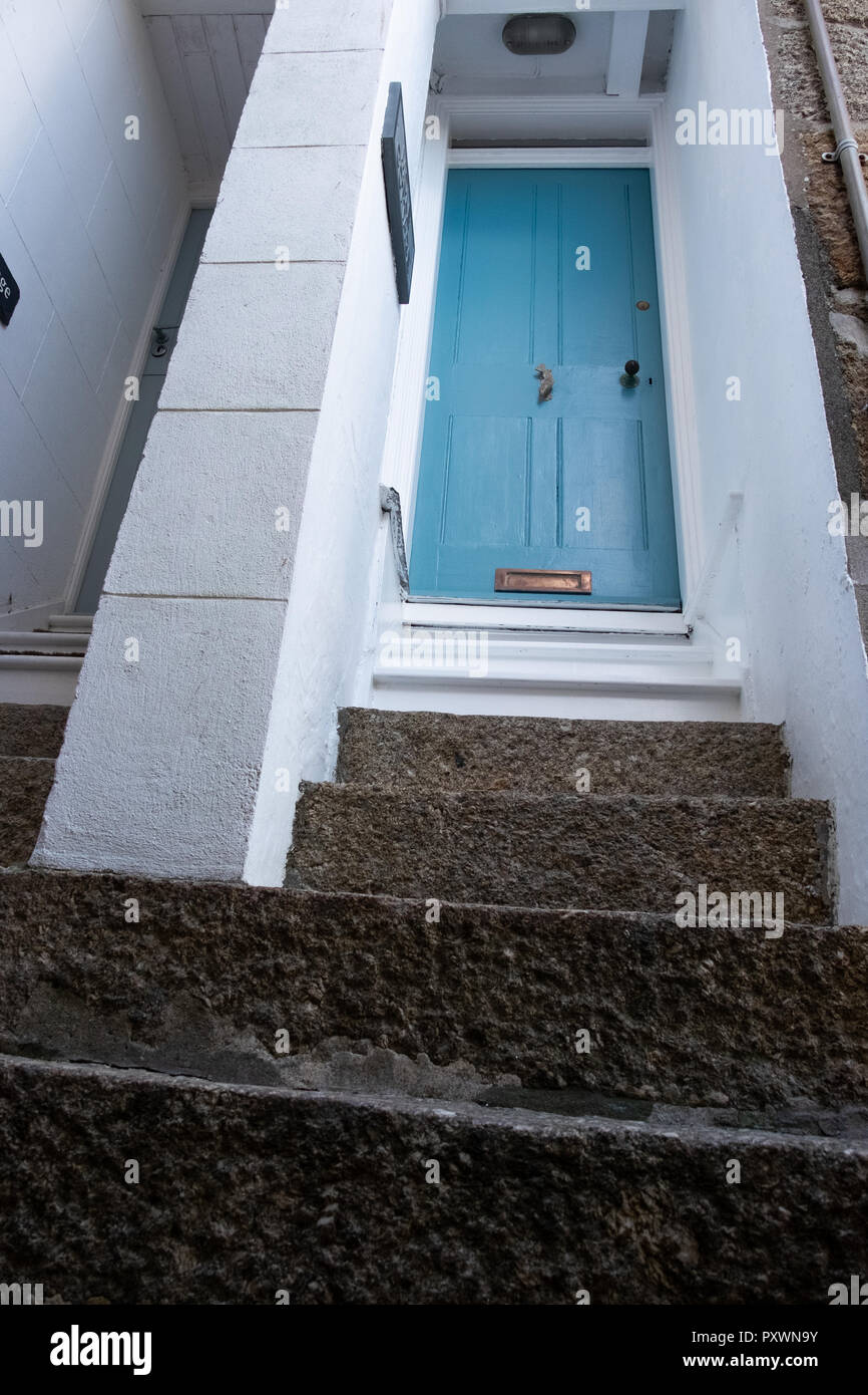 Period style wooden doorway with steep steps off a narrow alleyway in ...
