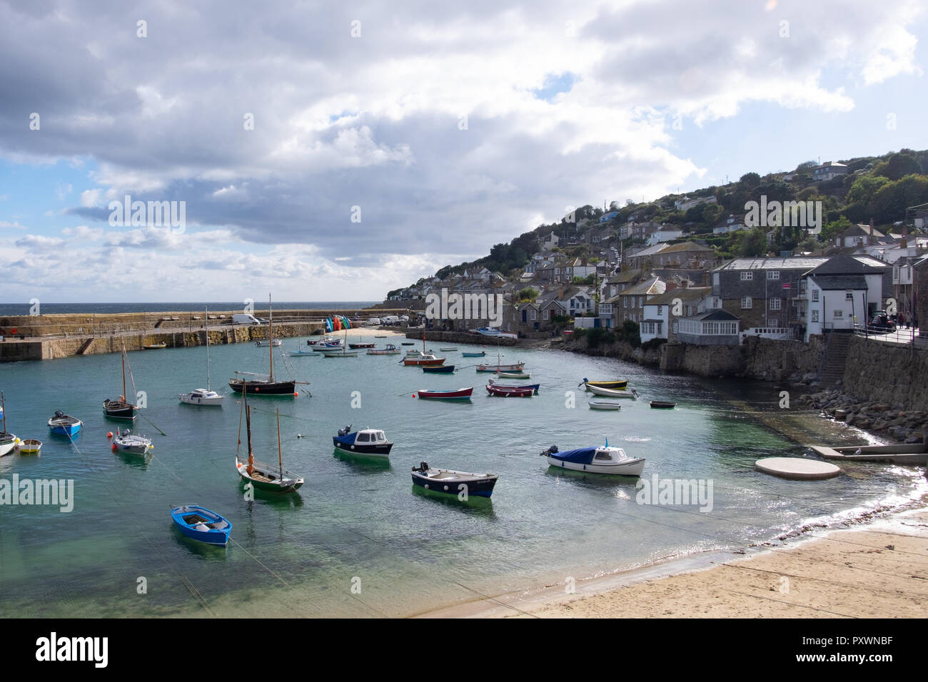 Wide angled view of Mousehole harbour in Cornwall showing the water in ...