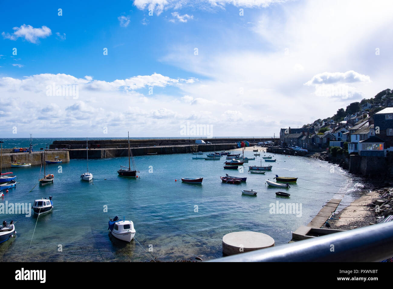 Wide angled view of Mousehole harbour in Cornwall showing the water in ...