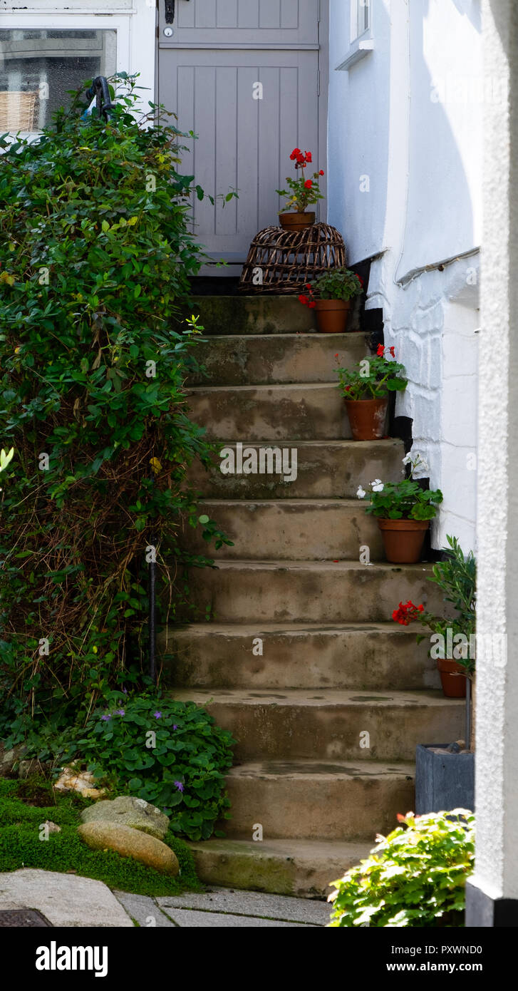 Steep, narrow, old steps on a narrow passageway in Mousehole, Cornwall ...