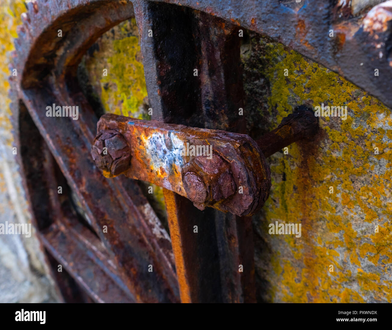 Part of large iron toothed cog wheel rising away in interesting ...