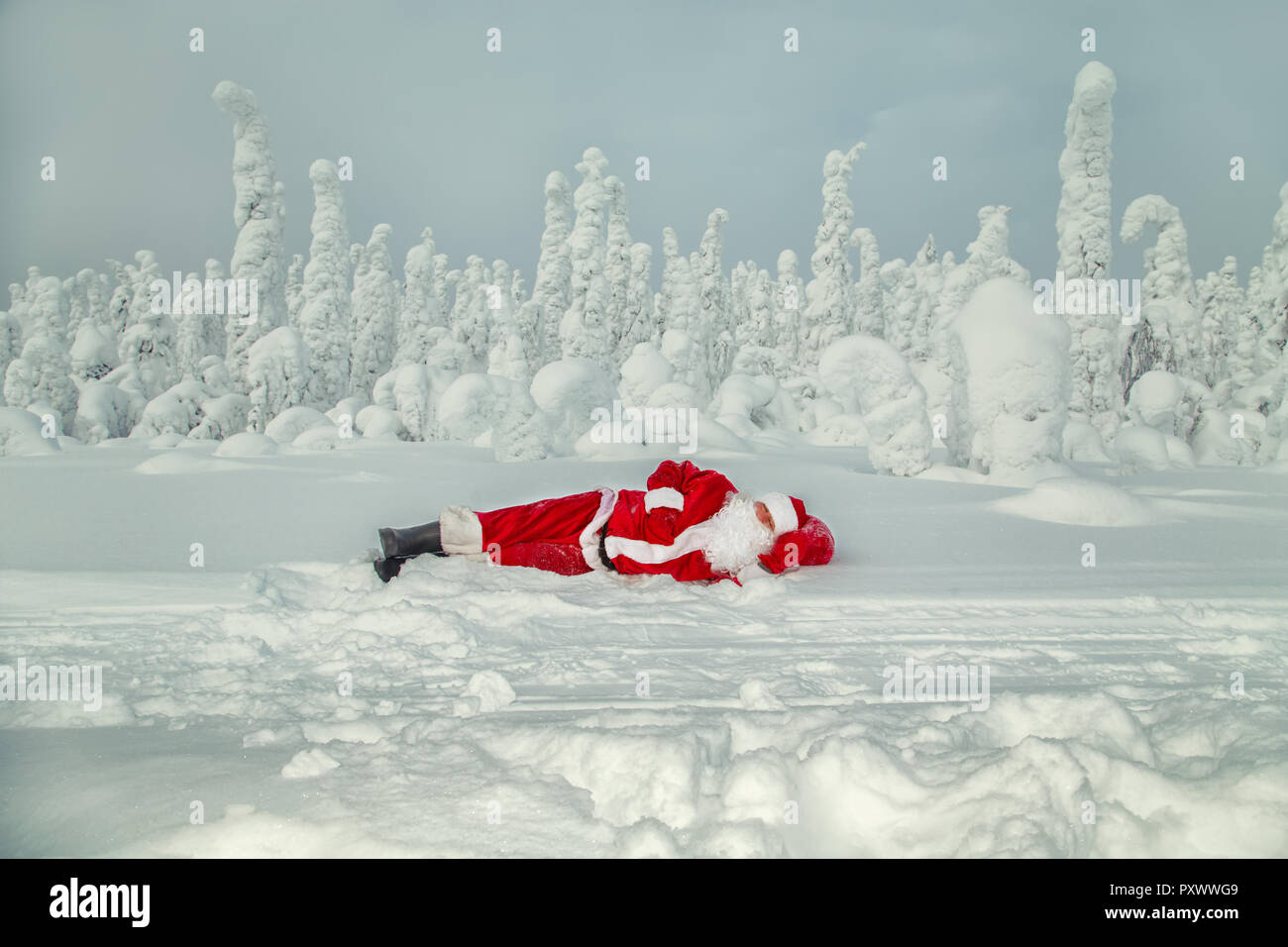 Tired Santa Claus fell asleep in the open air. Magnificent snow-covered ...
