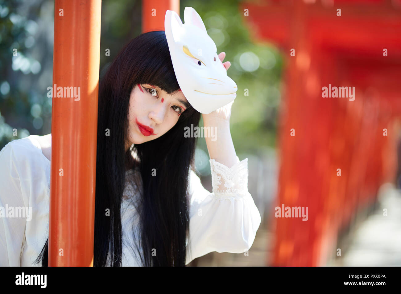 Young Japanese woman with fox mask Stock Photo - Alamy