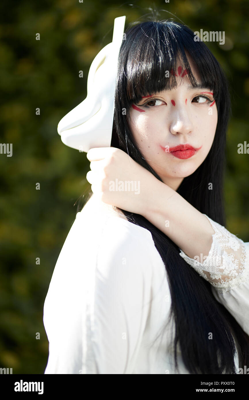 Young Japanese woman with fox mask Stock Photo - Alamy