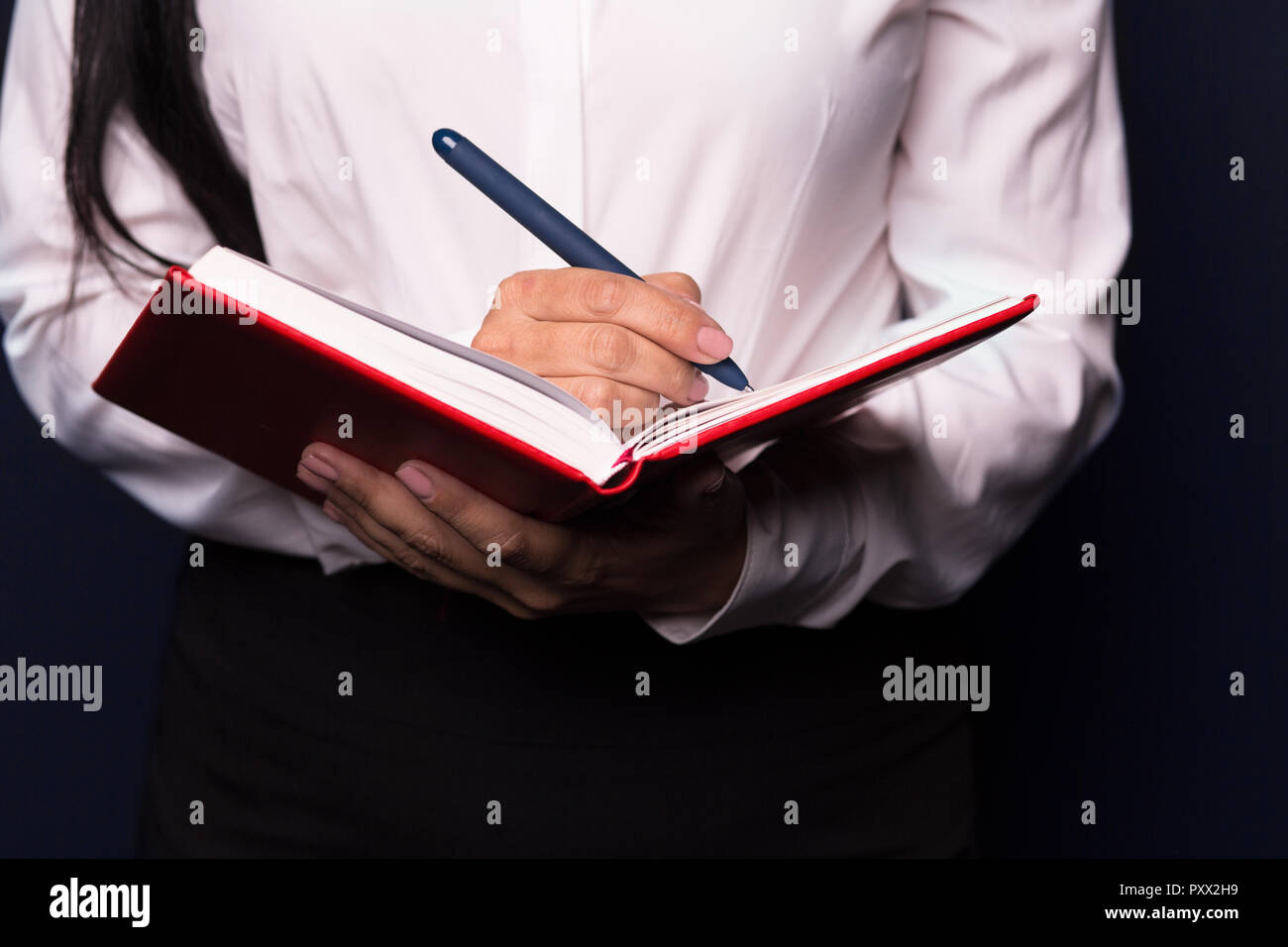 Young pretty business woman making notes Stock Photo - Alamy