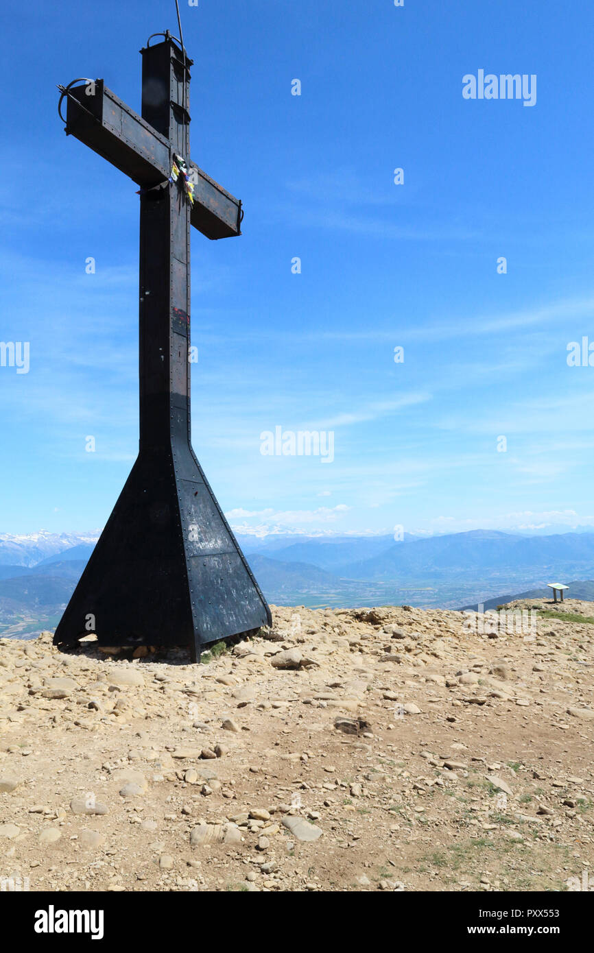 The Peña Oroel mountain black metal cross, with a deep blue sky and the ...