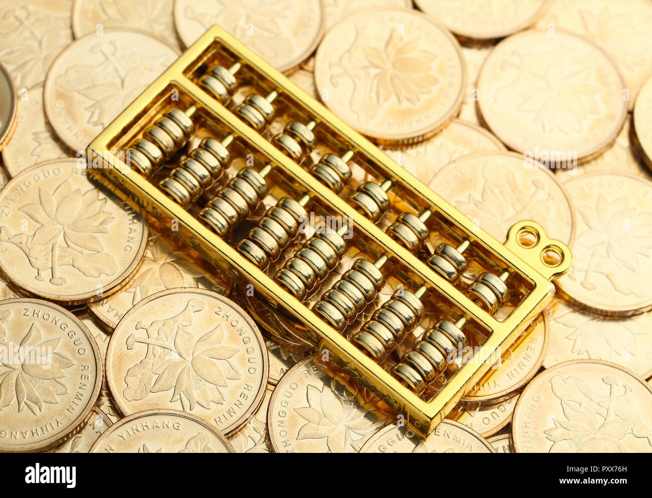 Golden Abacus with Chinese rmb gold coins as background Stock Photo - Alamy