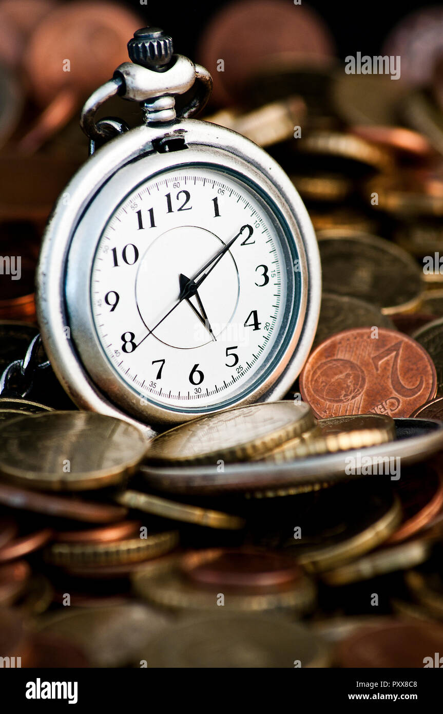 Time is money concept with clock and coins Stock Photo - Alamy