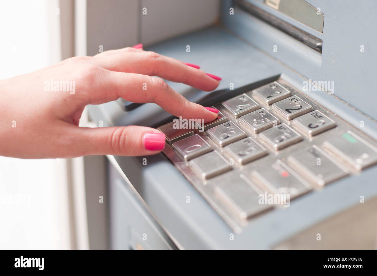 Finger pressing password number on ATM machine. Woman using banking machine. Close up Stock ...