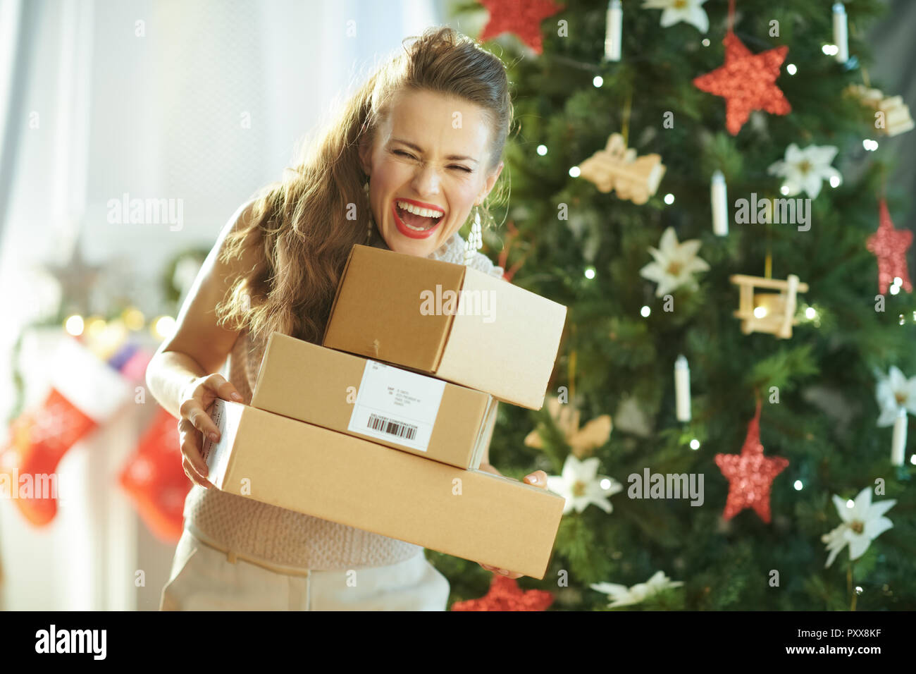 Woman catching christmas gift boxes hi-res stock photography and images ...