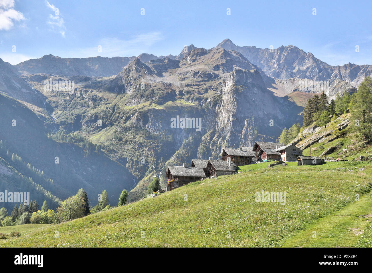 The Walser town of Dorf, with wood and stone lodges, high mountains ...