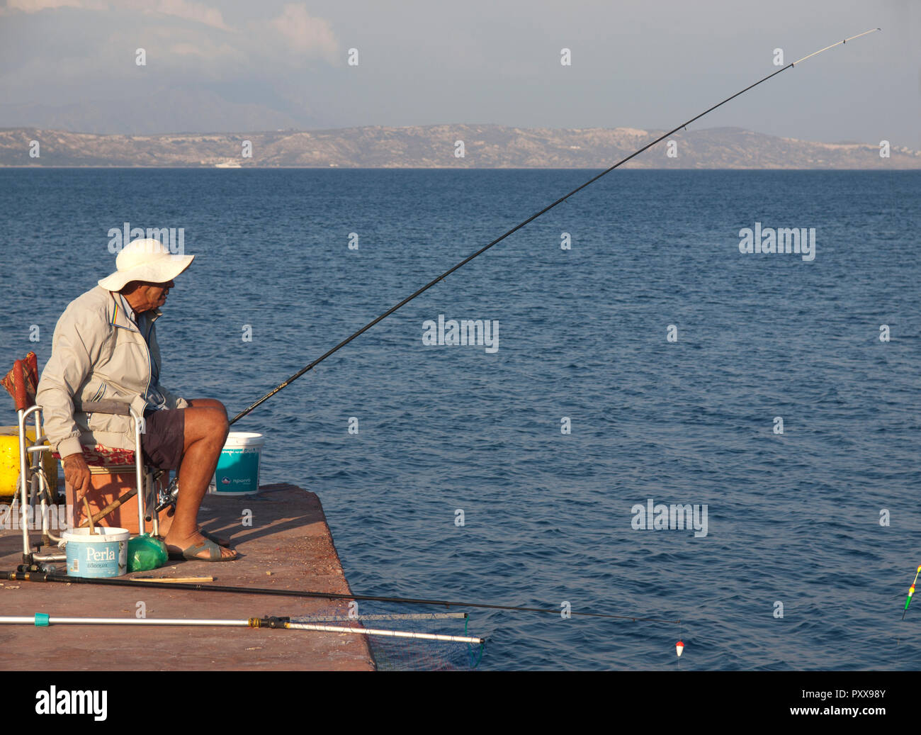 Fishing at the harbour in Kefalos, Kos Stock Photo - Alamy