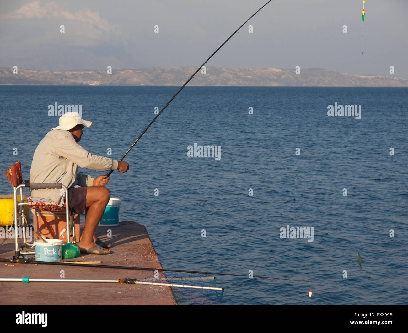 Fishing at the harbour in Kefalos, Kos Stock Photo - Alamy