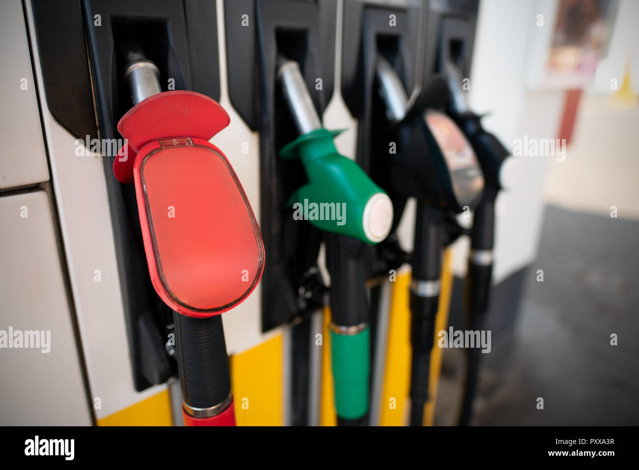 Petrol pump filling nozzles. Fuel at gas station close up Stock Photo ...