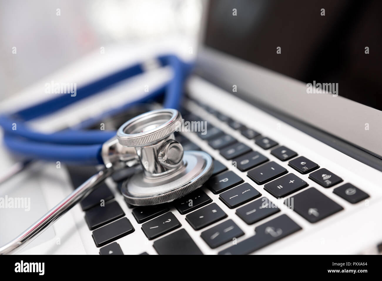 Stethoscope on laptop keyboard. Health care or IT security concept ...