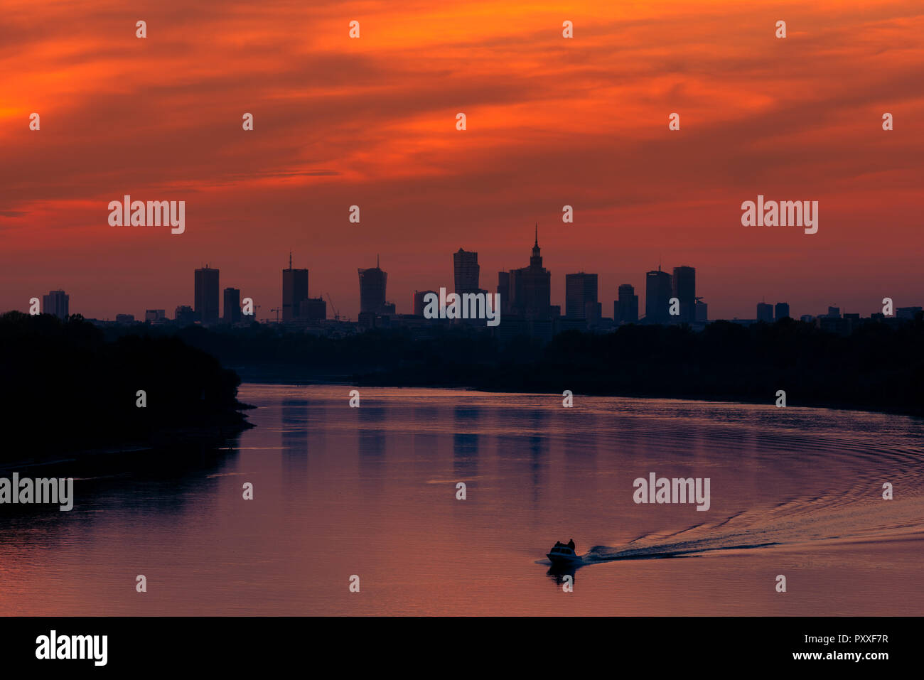 Sunset over the Warsaw city buildings by the Vistula river in Poland ...