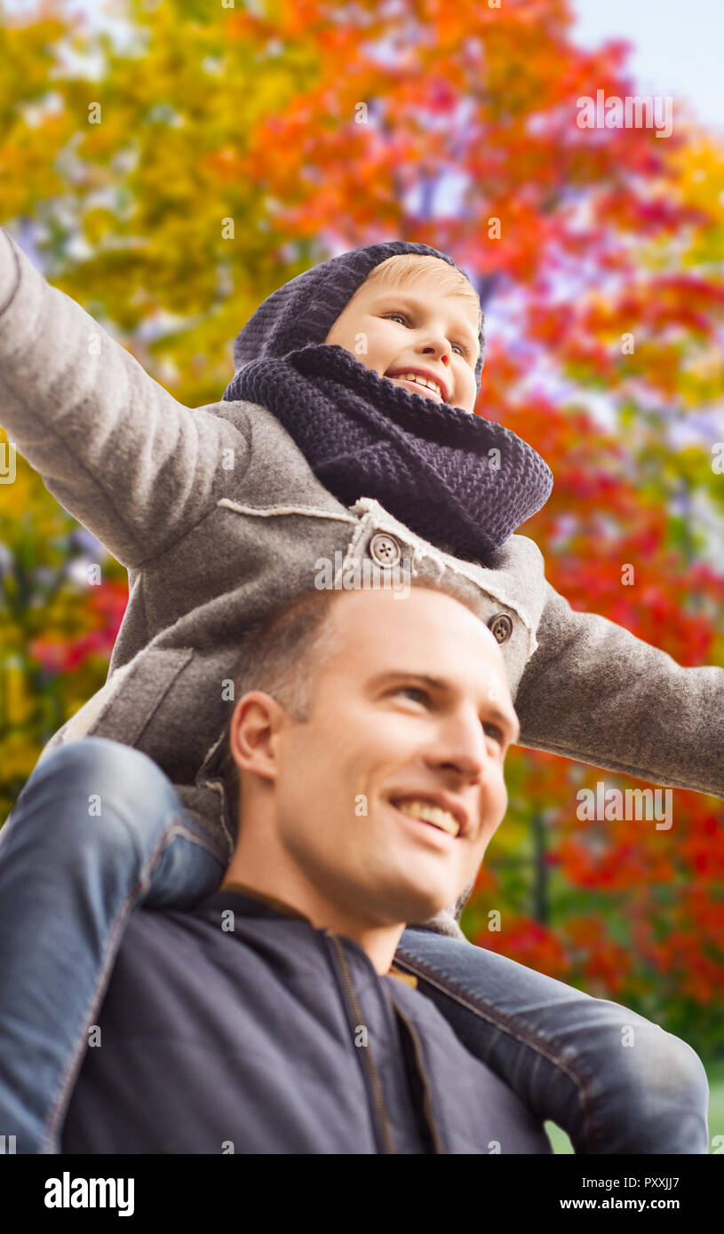 happy father carrying son over autumn park Stock Photo - Alamy
