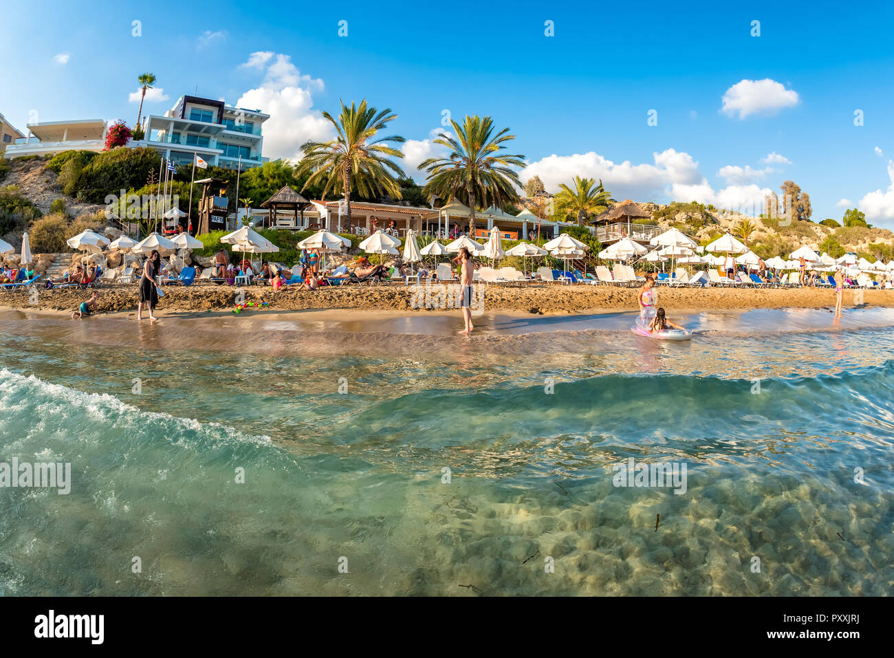 PAPHOS, CYPRUS - August 20, 2017: People relaxing at Coral Bay Beach ...