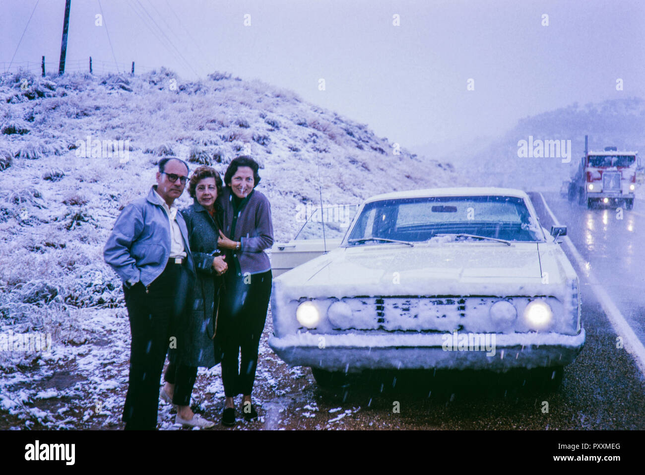 November 1965 and a family pose for a picture along a snowy highway in ...
