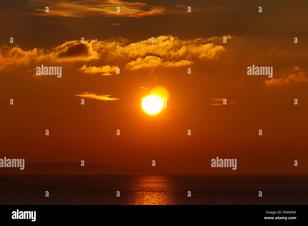 The bright sun sending a streak of sunlight across the sea Stock Photo ...