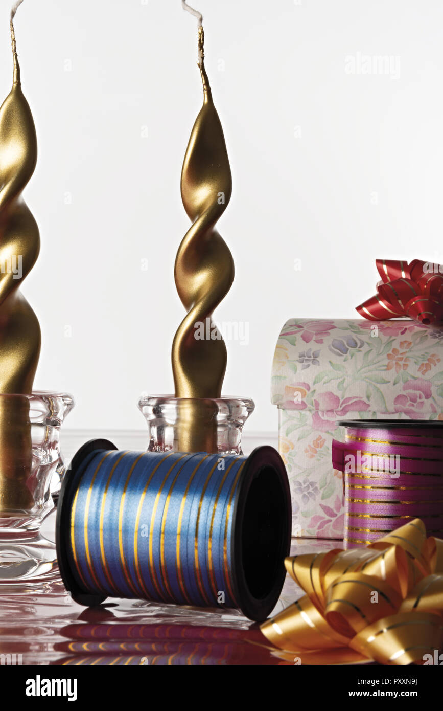 gold color party candles with box and ribbons in front Stock Photo - Alamy