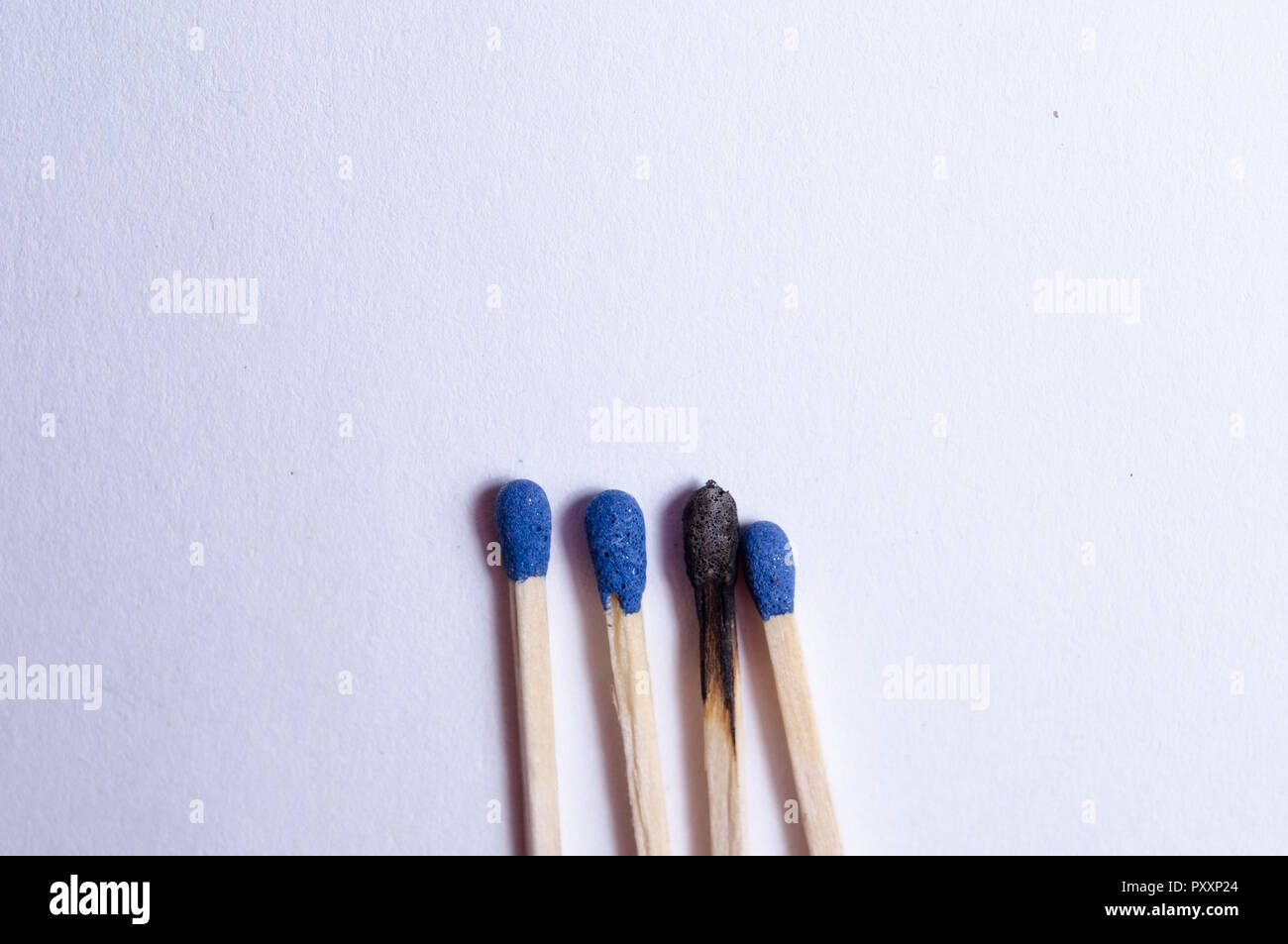 group of 4 matches and a burnt match, on a white background isolated ...