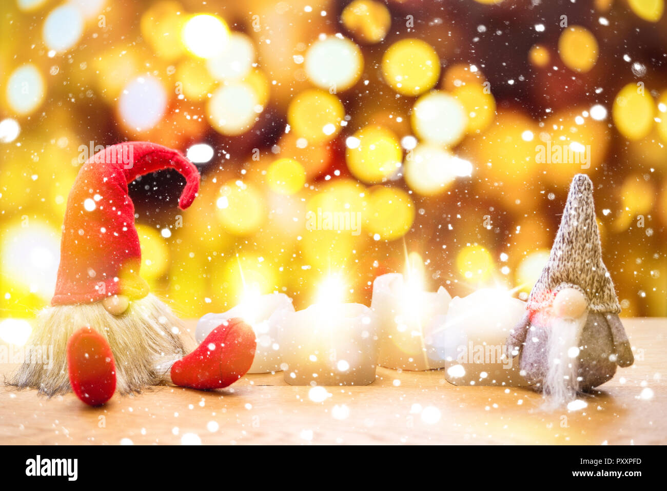Two sitting christmas elfs with bokeh lights in background surrounded ... Two sitting christmas elfs with bokeh lights in background surrounded ...
