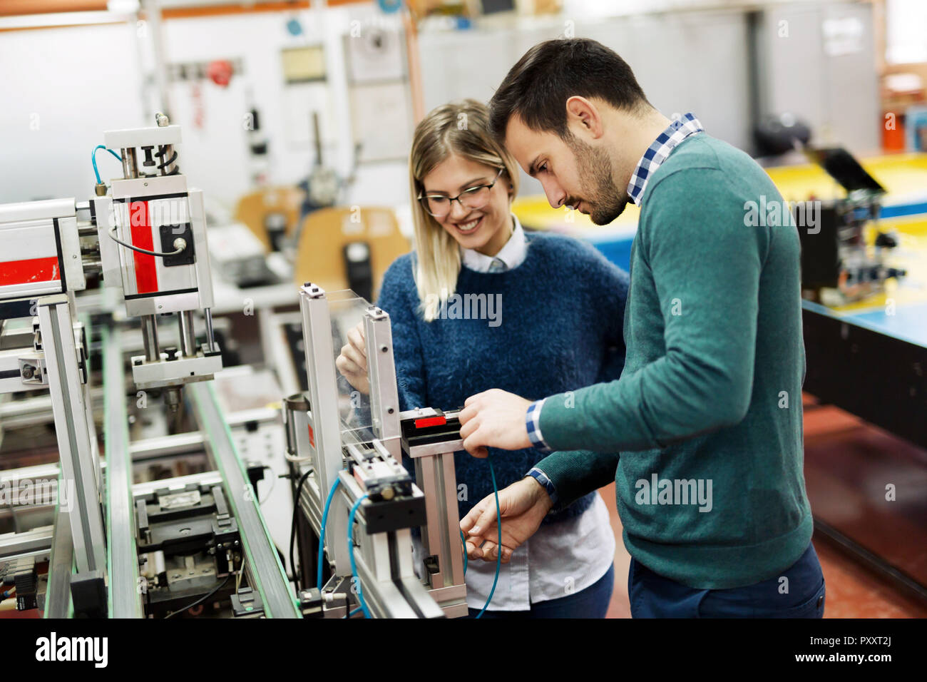 Young attractive students of mechatronics working on project Stock ...