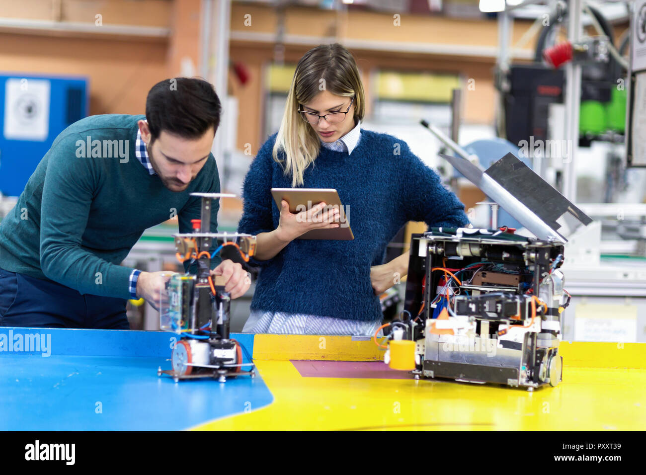 Young attractive students of mechatronics working on project Stock ...