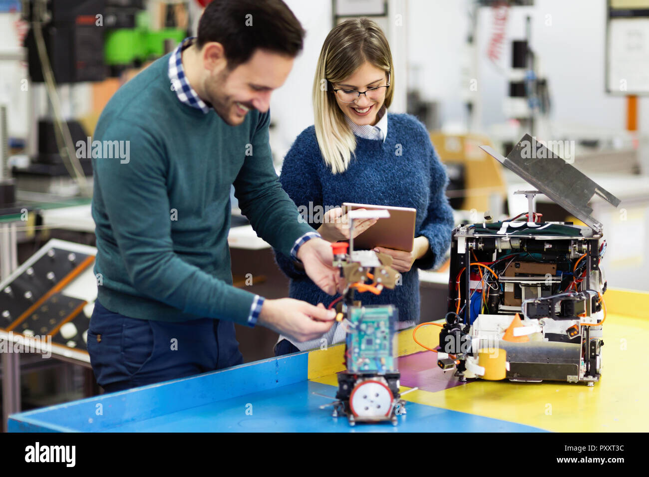 Young attractive students of mechatronics working on project Stock ...
