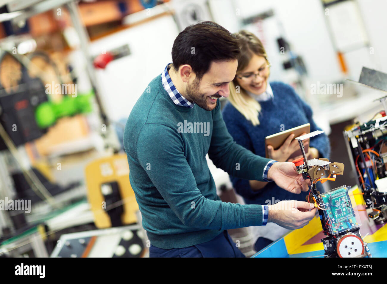Young attractive students of mechatronics working on project Stock ...