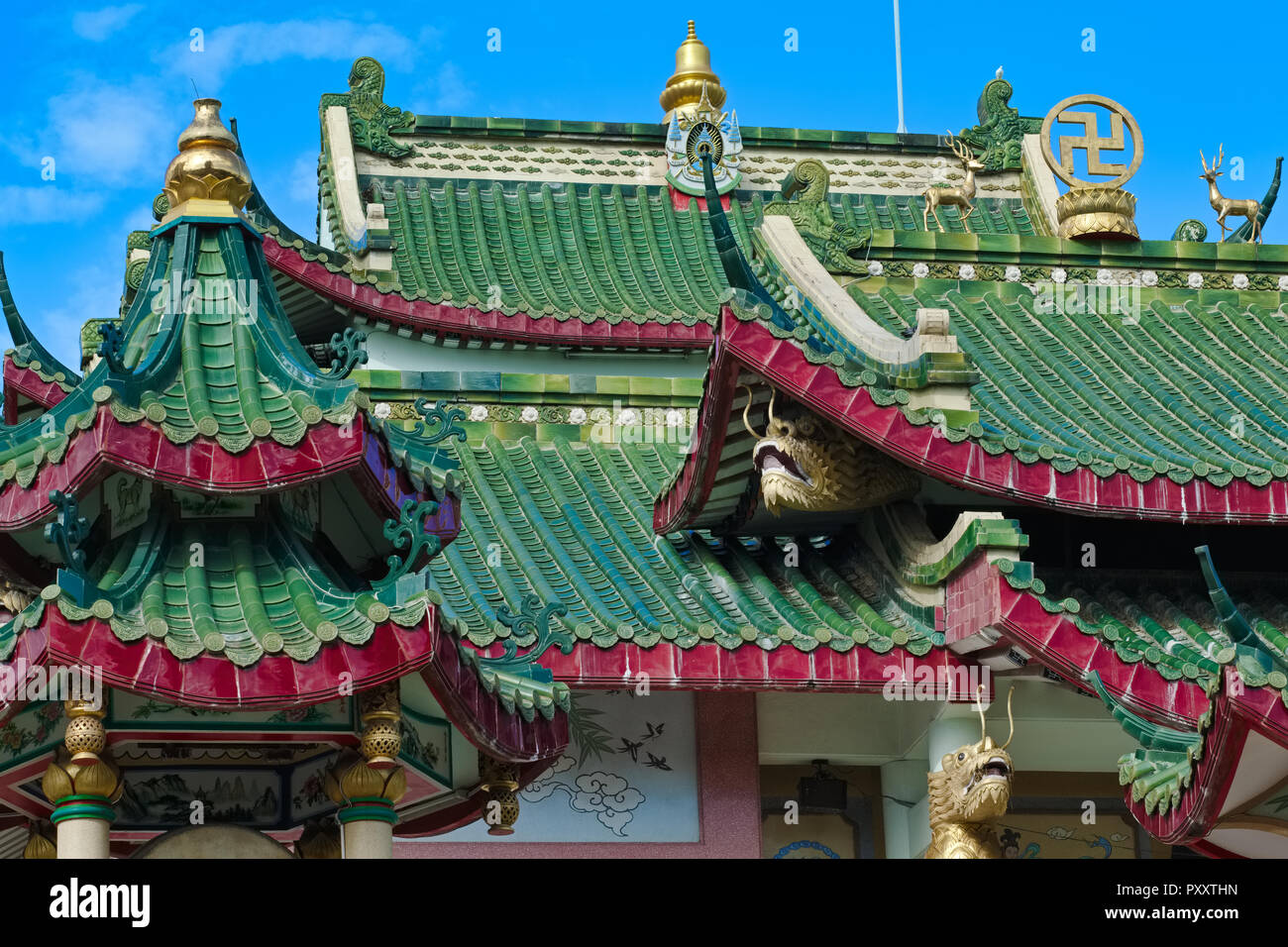 The roof of the Chee Chin Khor Temple, with dragon heads and a swastika ...
