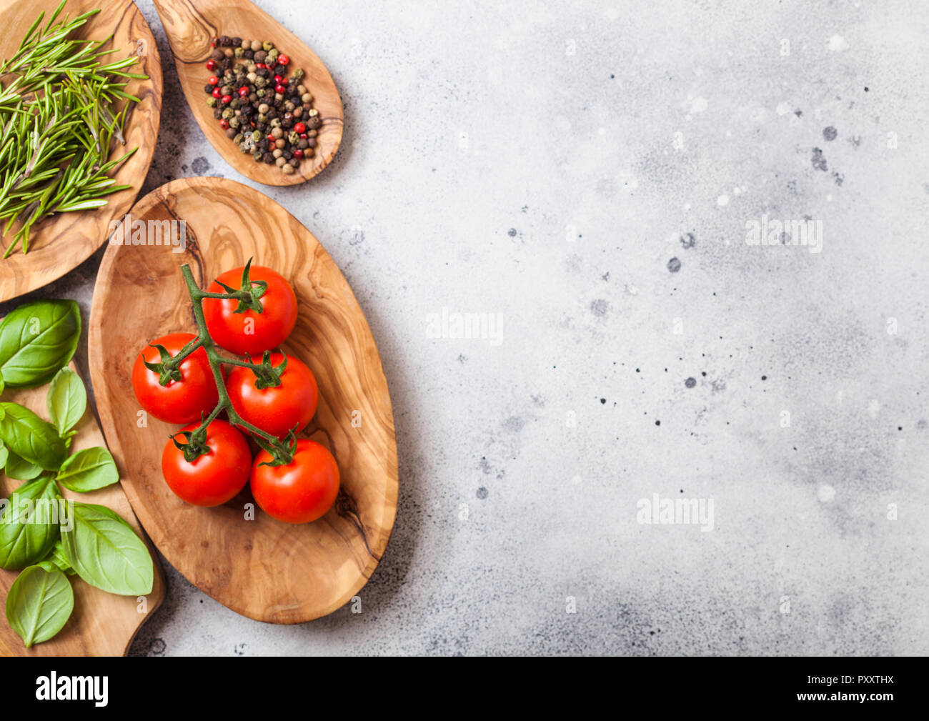 Organic Cherry Sugardrop Tomatoes on the Vine with basil in oilve wood ...
