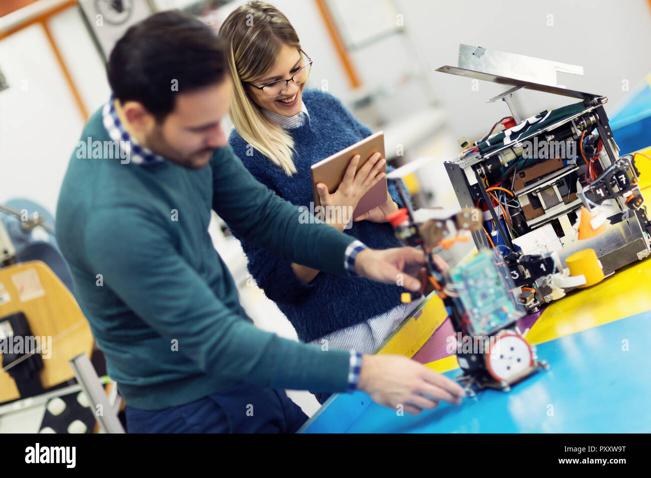 Young attractive students of mechatronics working on project Stock ...