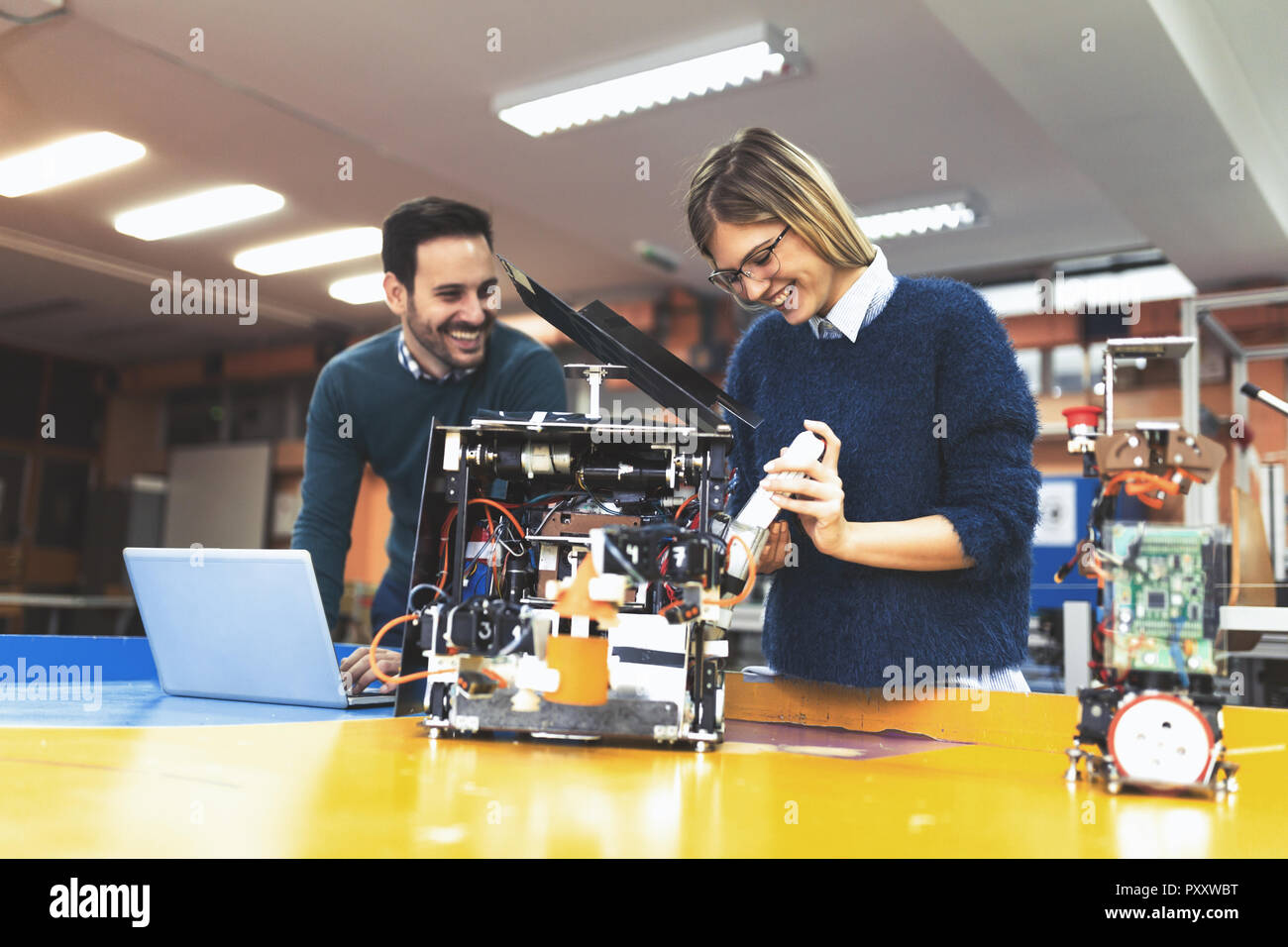 Young attractive students of mechatronics working on project Stock ...